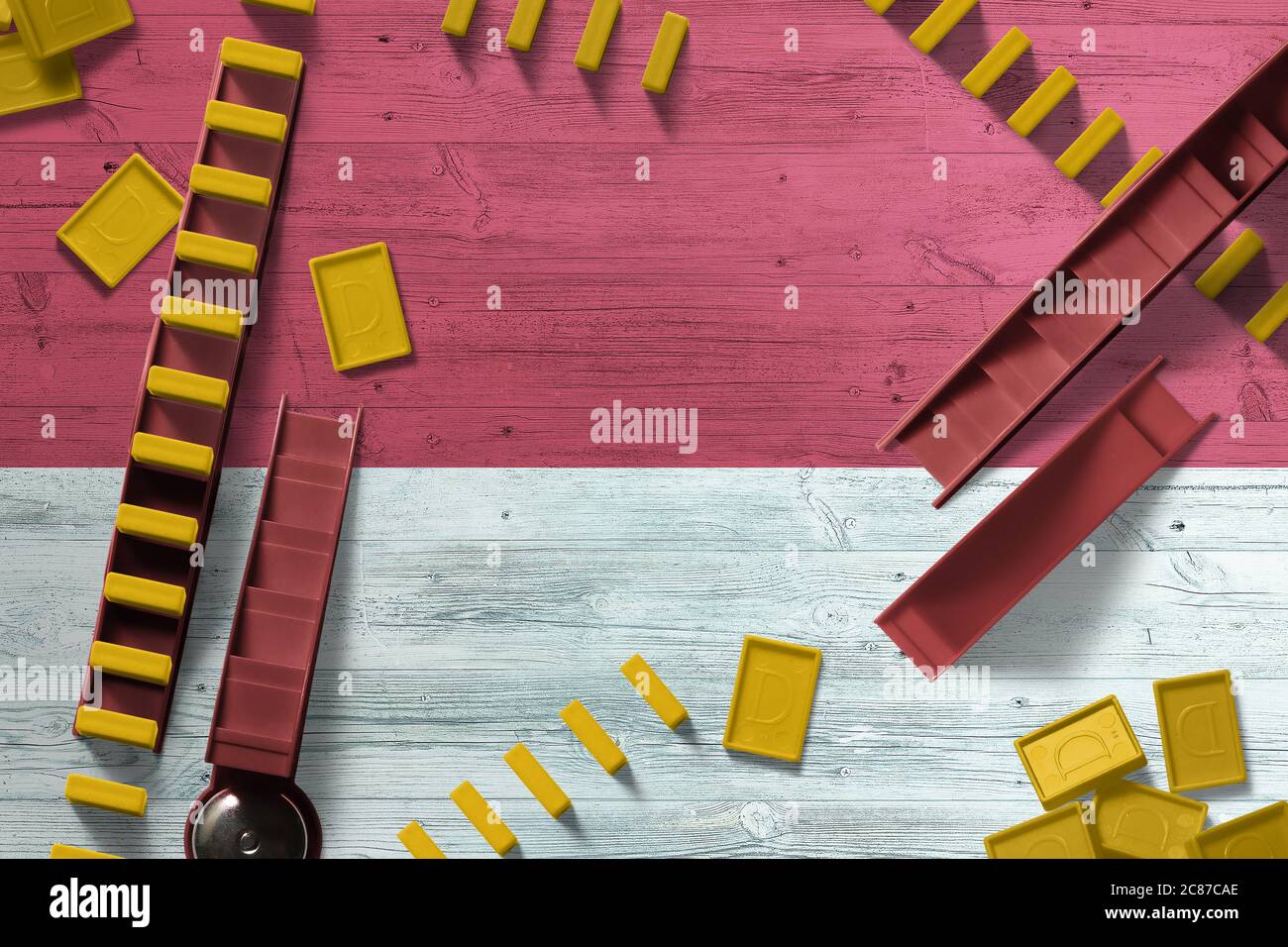 Monaco flag with national background with dominoes on wooden table. Top ...