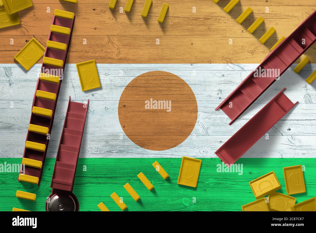 Niger flag with national background with dominoes on wooden table. Top ...