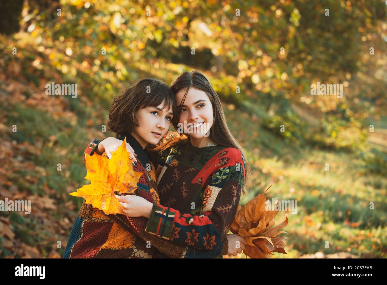 Fall Season Outdoor Activity. Leisure. Two smiling girls in a park ...