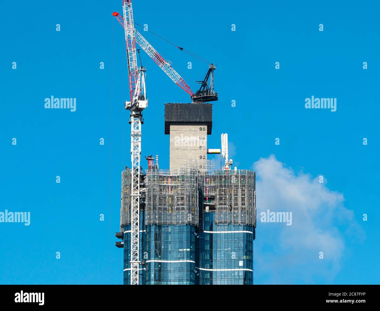 Construction site of modern multi-level building with a clear blue sky ...