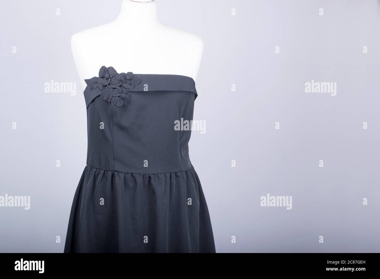 A Tailors Mannequin dressed in a Black Dress with Flower Stock Photo ...