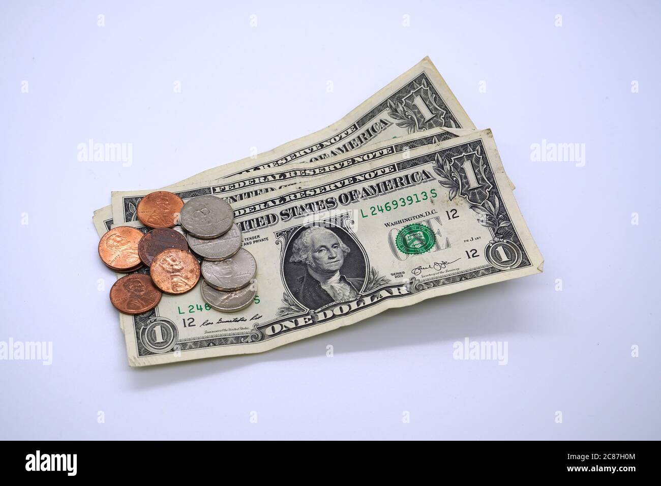 Assorted US currency with dollars and cents on a white background Stock ...