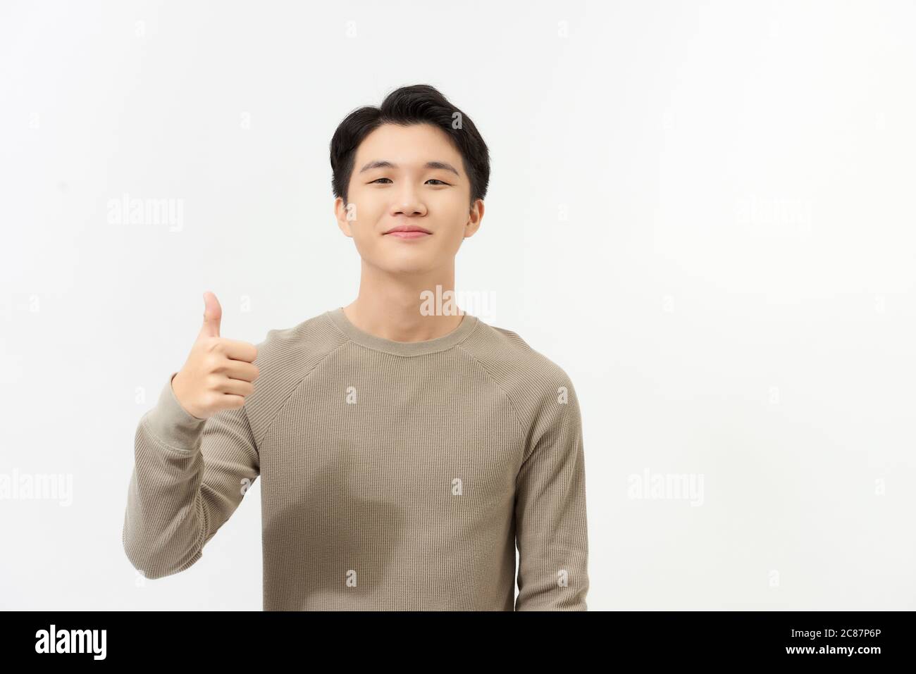 Happy young man giving thumbs up success hand sign smiling and happy ...