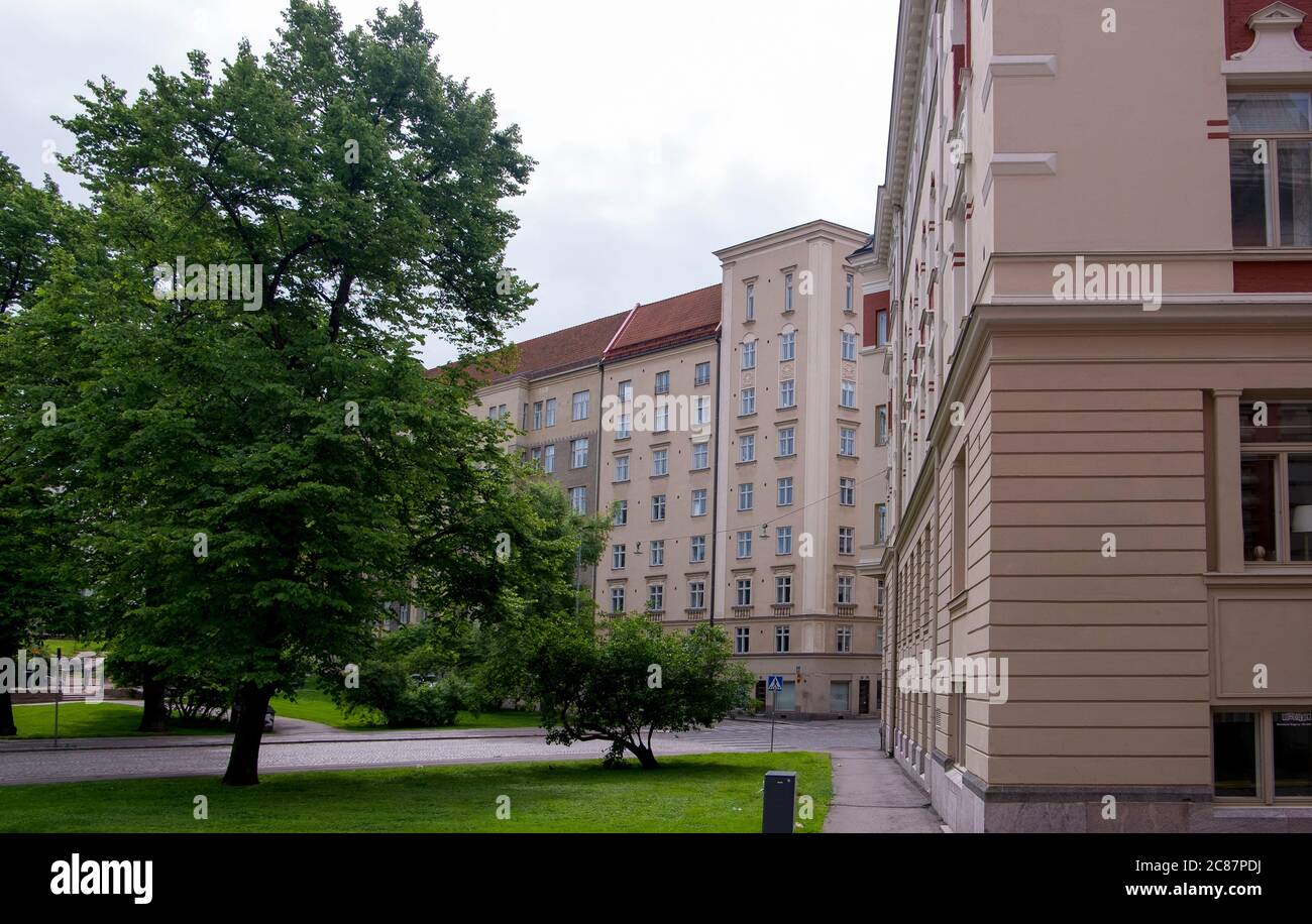 A view of a quiet, small, urban park and surrounding buildings on a ...