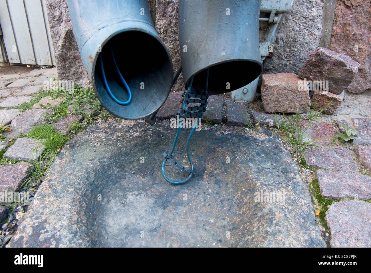 Detail of electrical wire loops in a drain pipe, used to heat and melt ...
