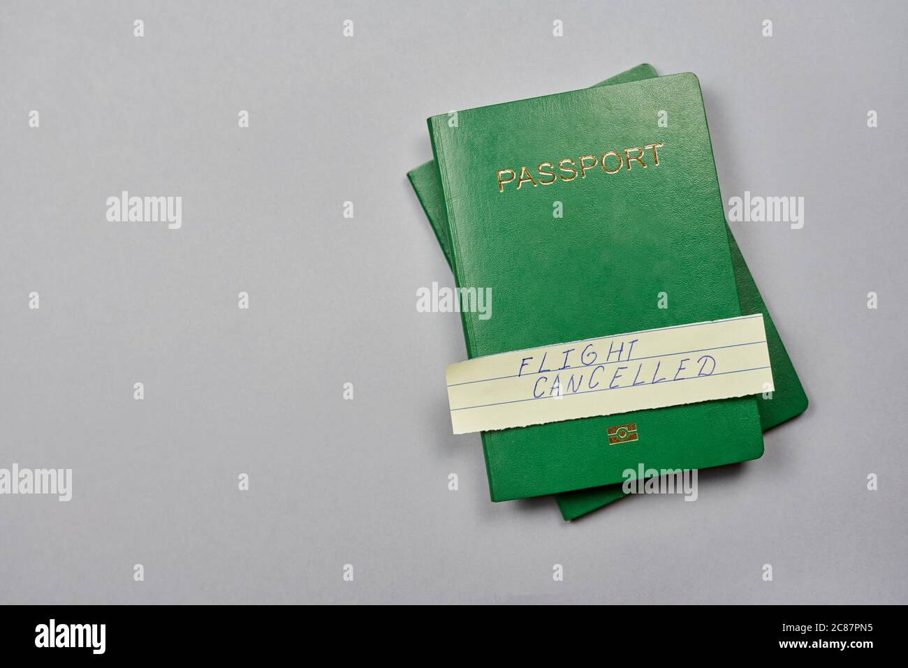 A passport and sticker with words - Flight cancelled. COVID-19 and ...