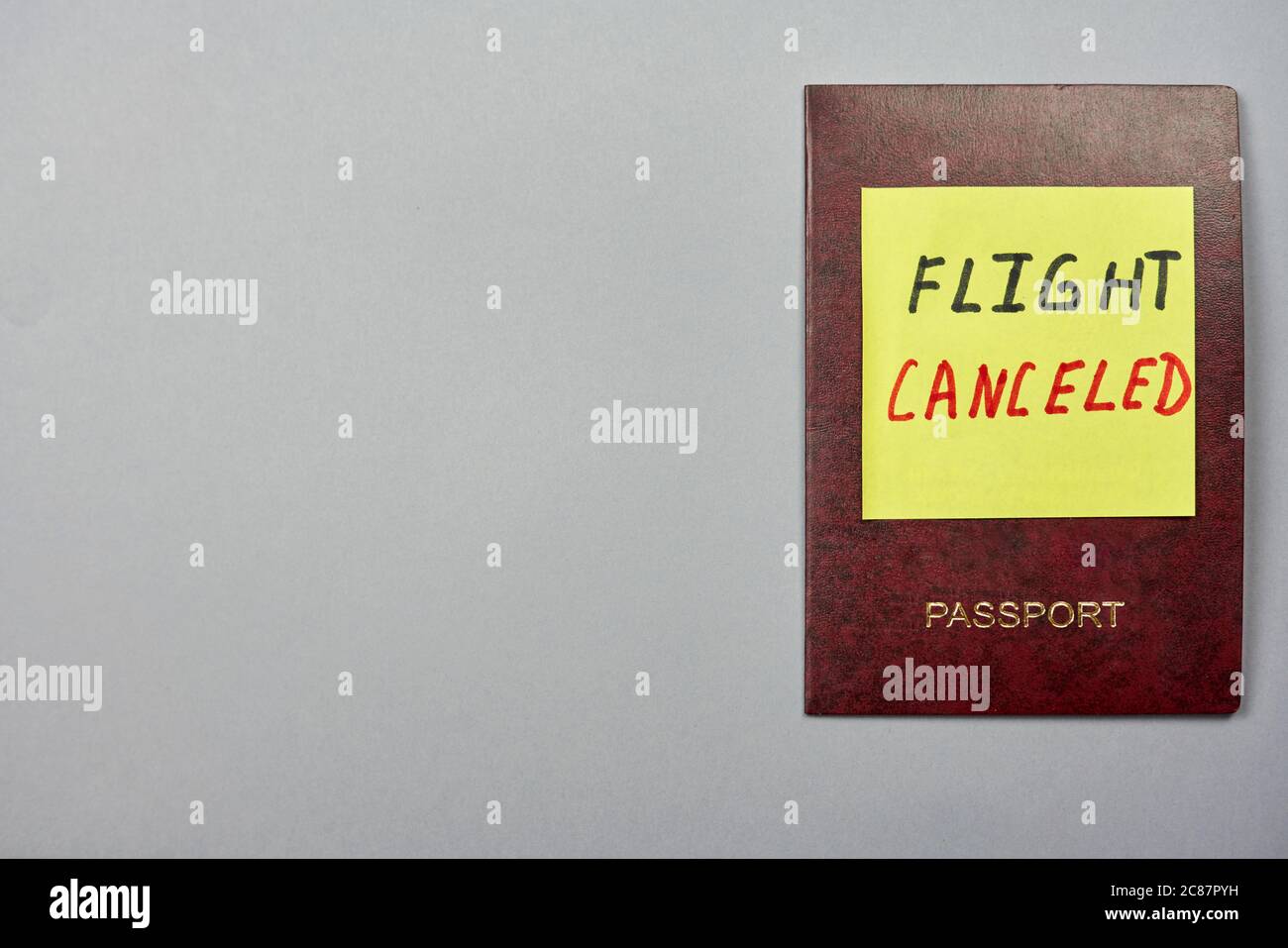A passport and sticker with words - Flight cancelled. COVID-19 and ...