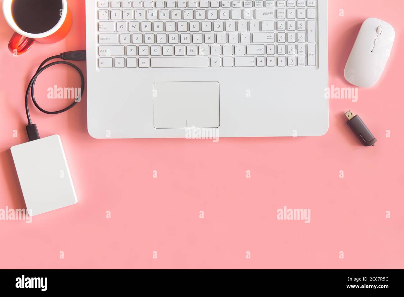 Pastel pink desk office with laptop, smartphone and other work supplies ...