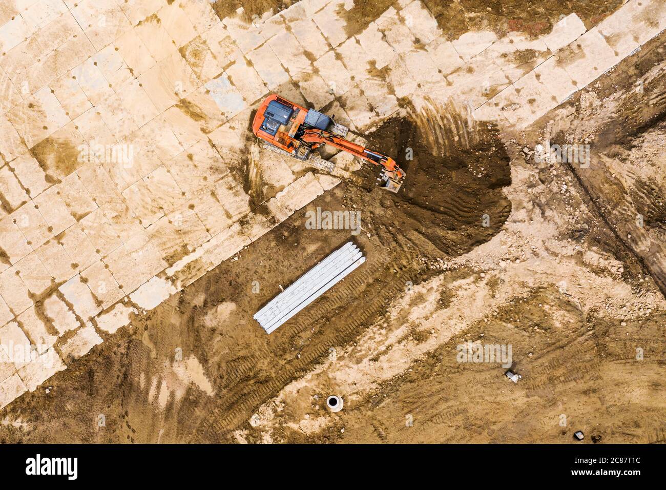 working excavator on construction site. producing earthworks. top view ...