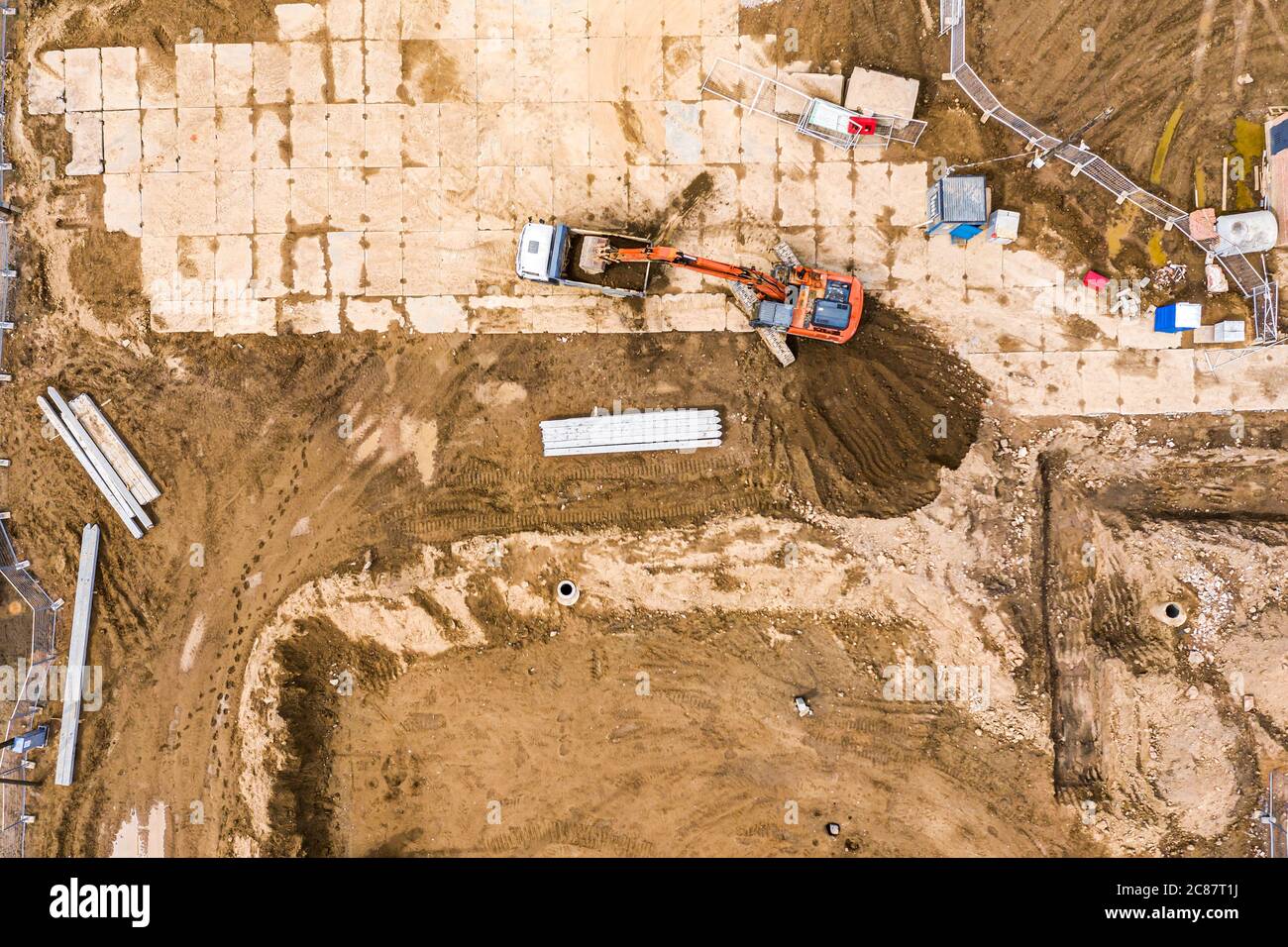 excavator moving ground and loading into a dumper truck on construction ...