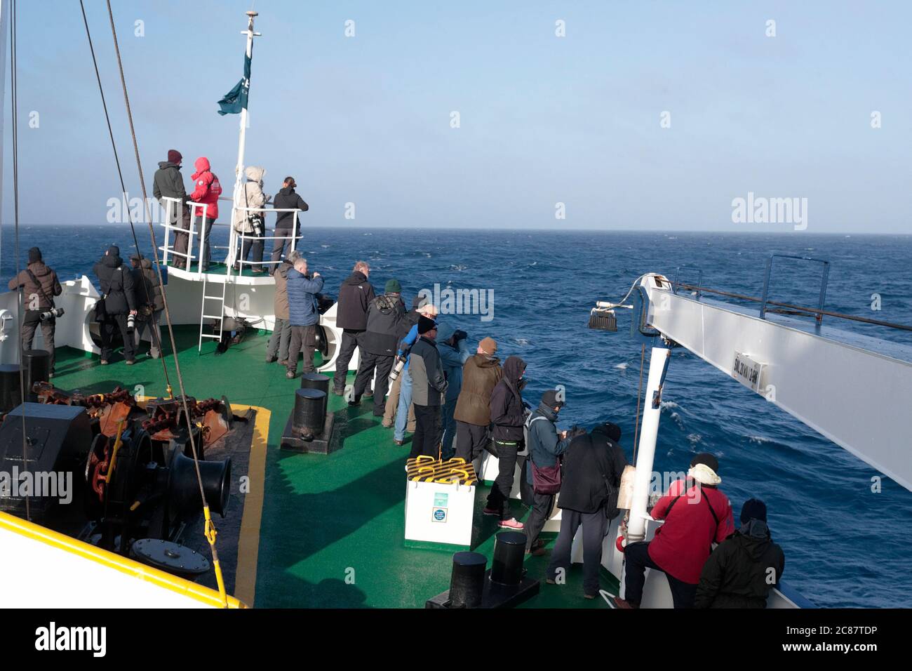 Seawatching birders occupy the foredeck as MV Plancius cruises the ...