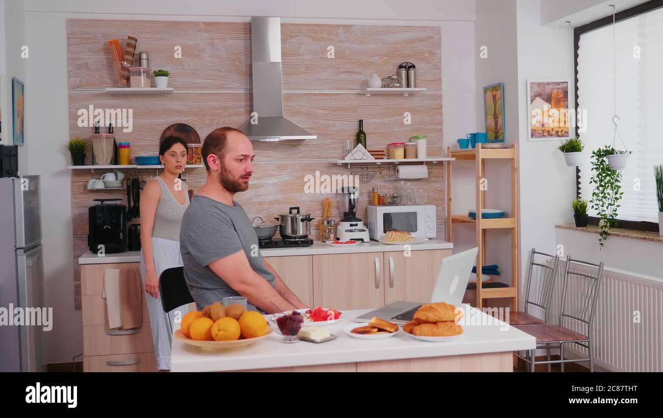 Angry businessman during breakfast because of a bad news. Unhappy ...