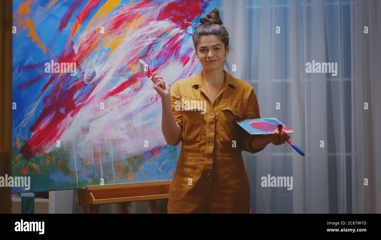 Portrait of abstract painter smiling in art workshop Stock Photo - Alamy