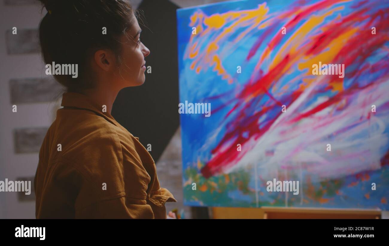 Creative pensive painter in workshop admiring her work Stock Photo - Alamy
