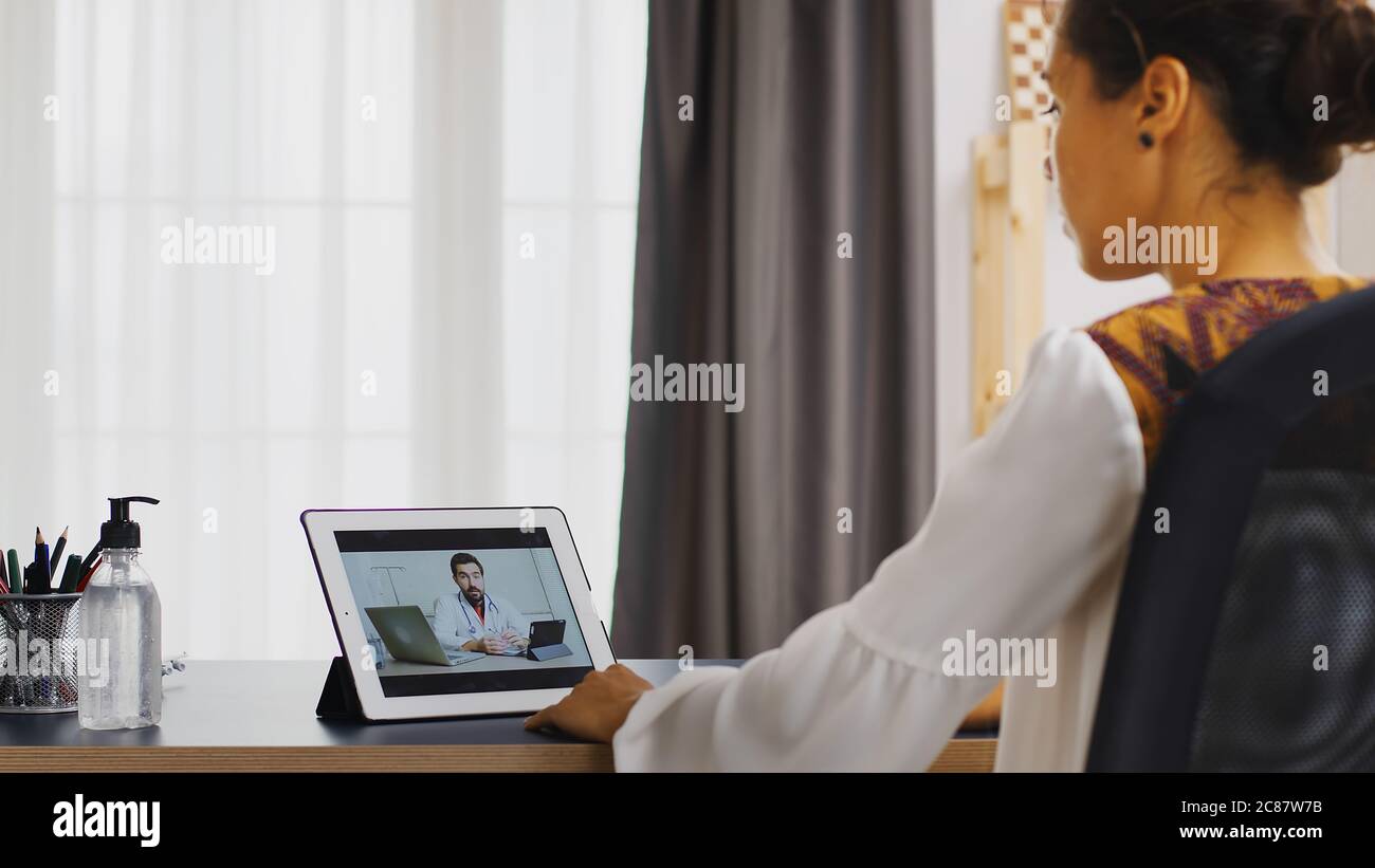 Female patient in a video call with her doctor talking about her ...