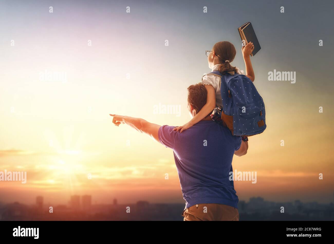 Parent and pupil of primary school on sunset background. Man and girl ...