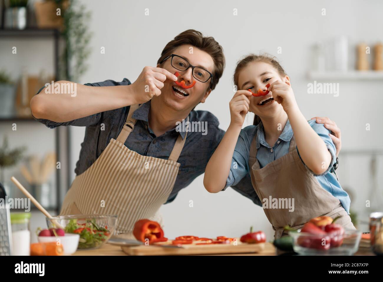 Healthy food at home. Happy family in the kitchen. Father and child ...