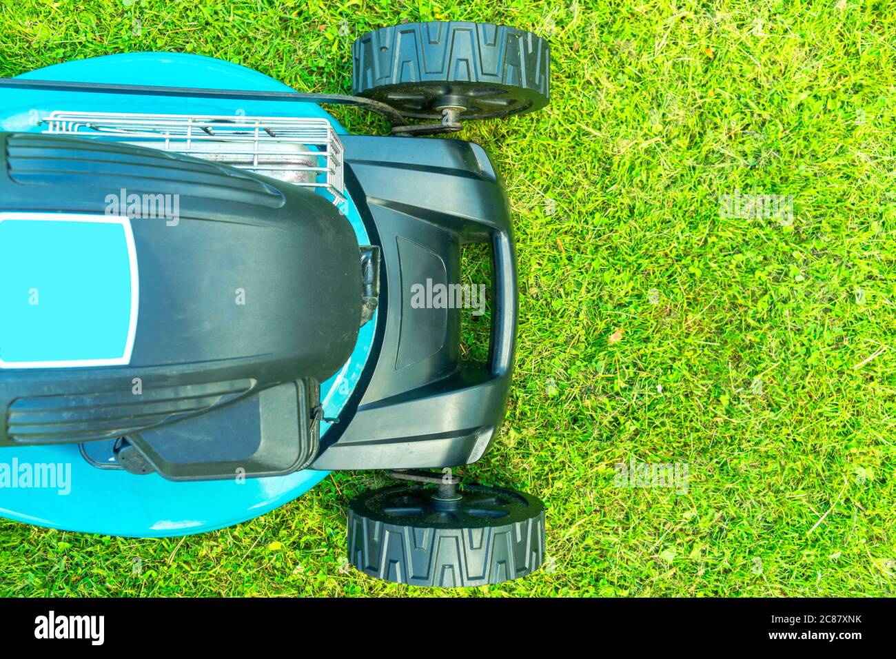 Mowing lawns. Top view lawn mower on green grass. Mower grass equipment ...