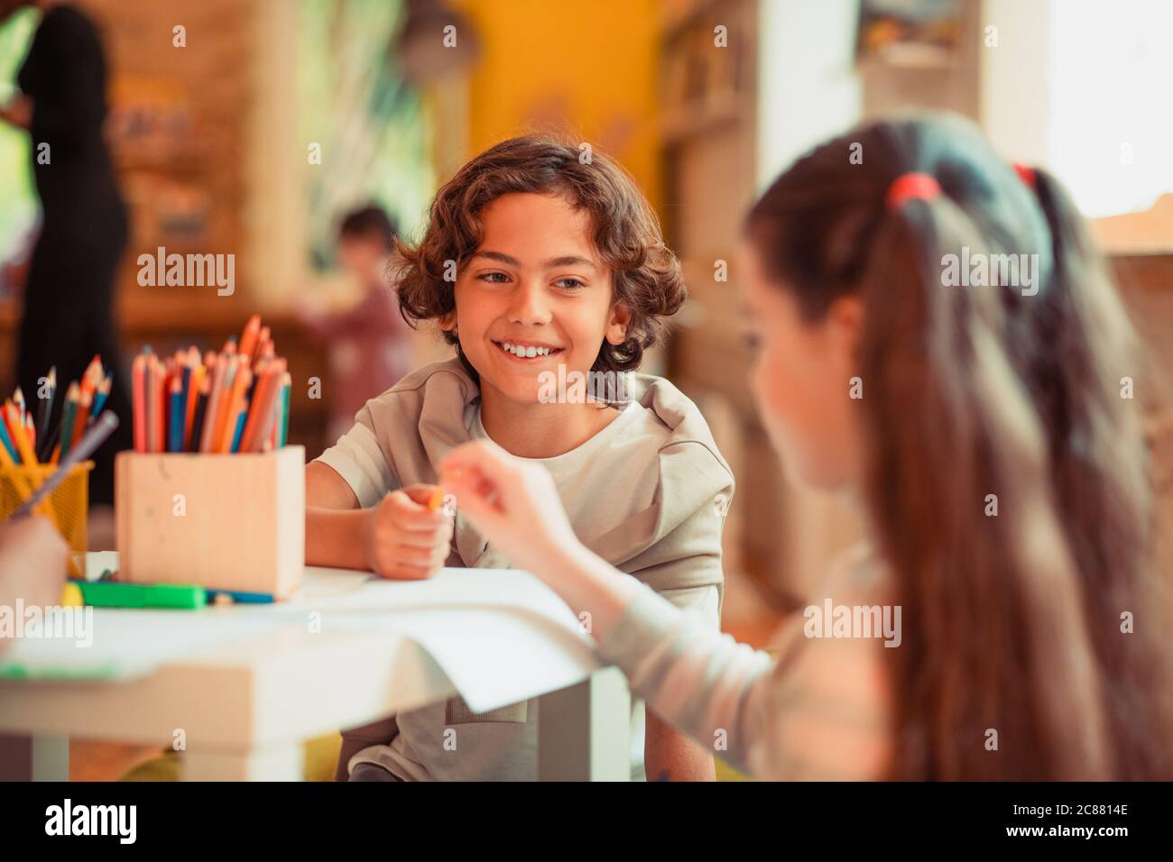 Smiling boy visiting an art class together with his peers Stock Photo ...