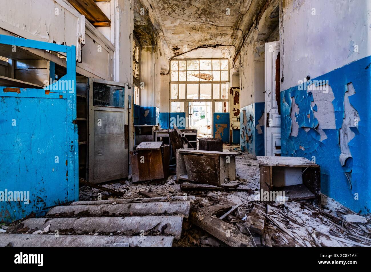 Ruined corridor with piles of garbage in abandoned building Stock Photo ...