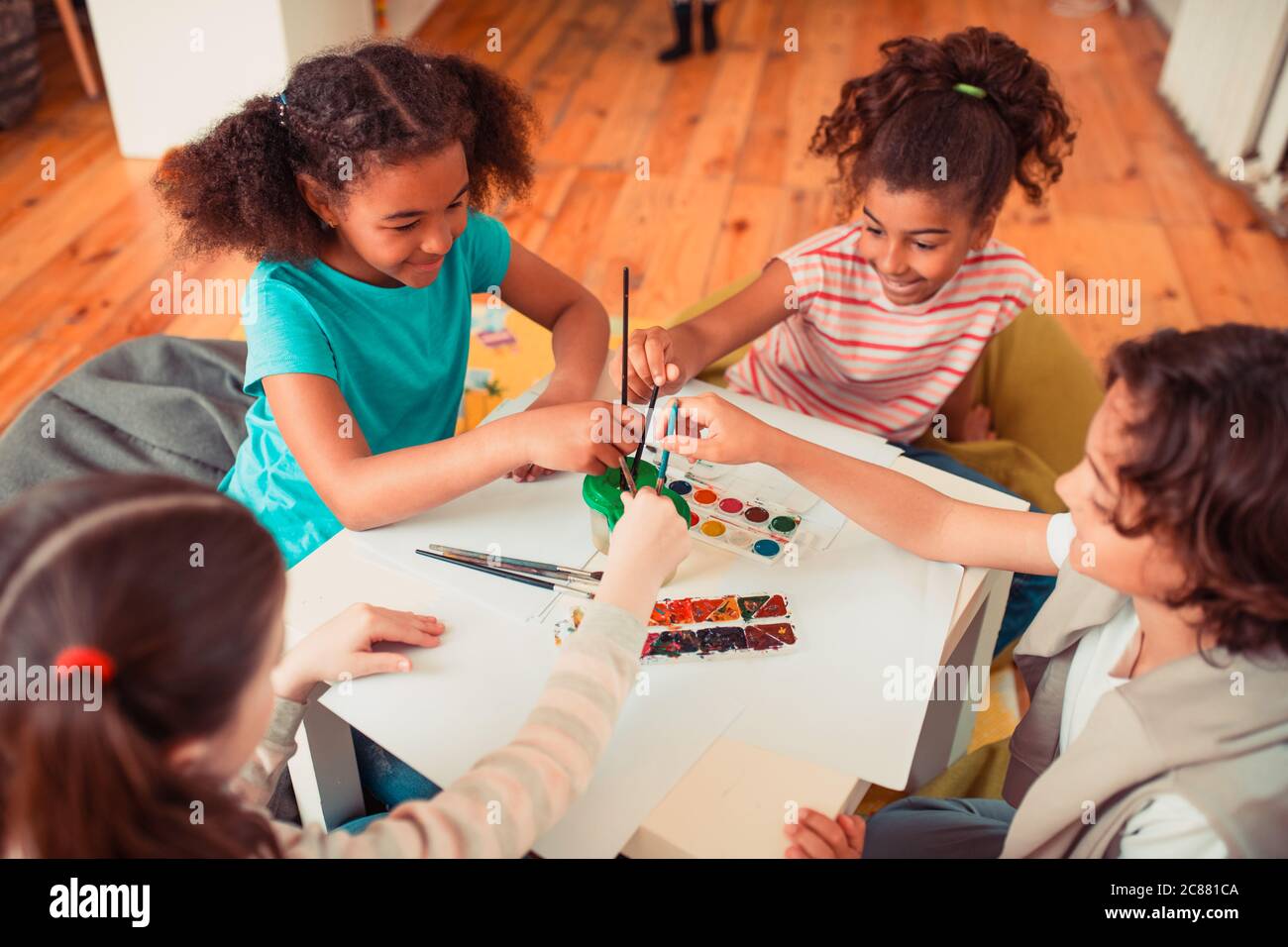 Group of children painting with watercolors together Stock Photo - Alamy