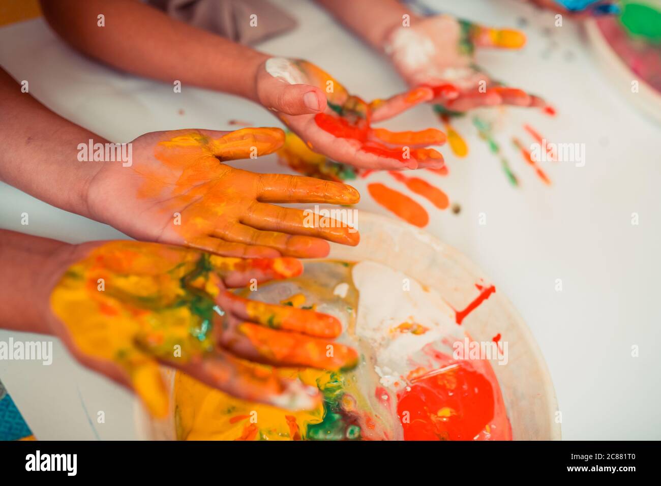 Children putting paint on their hands during art practices Stock Photo ...