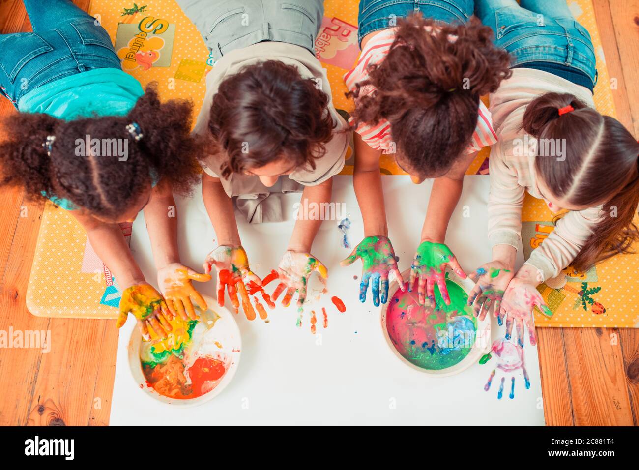 Children painting with their hands during the art class Stock Photo - Alamy