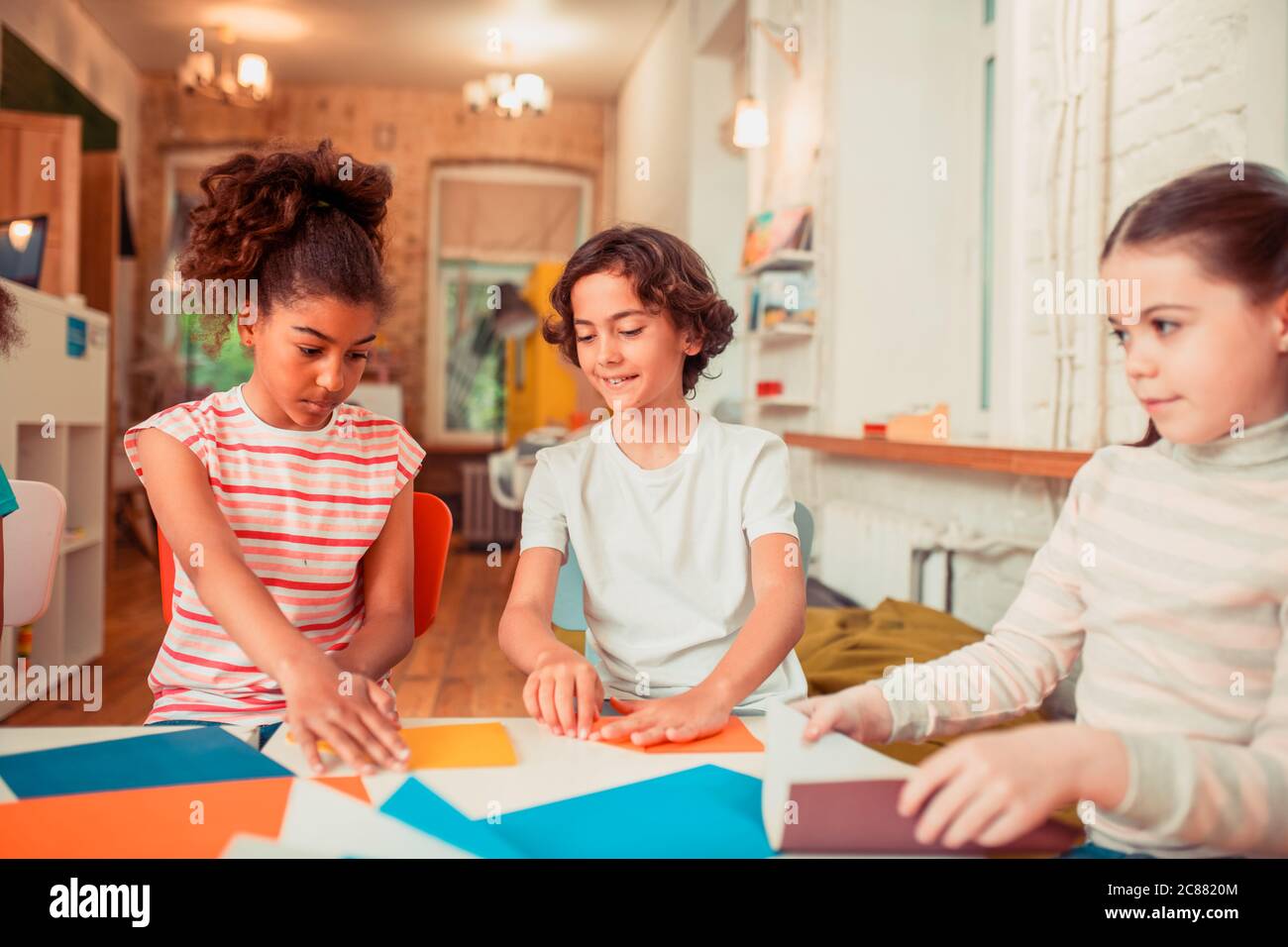 Children learning to make origami in the class Stock Photo - Alamy