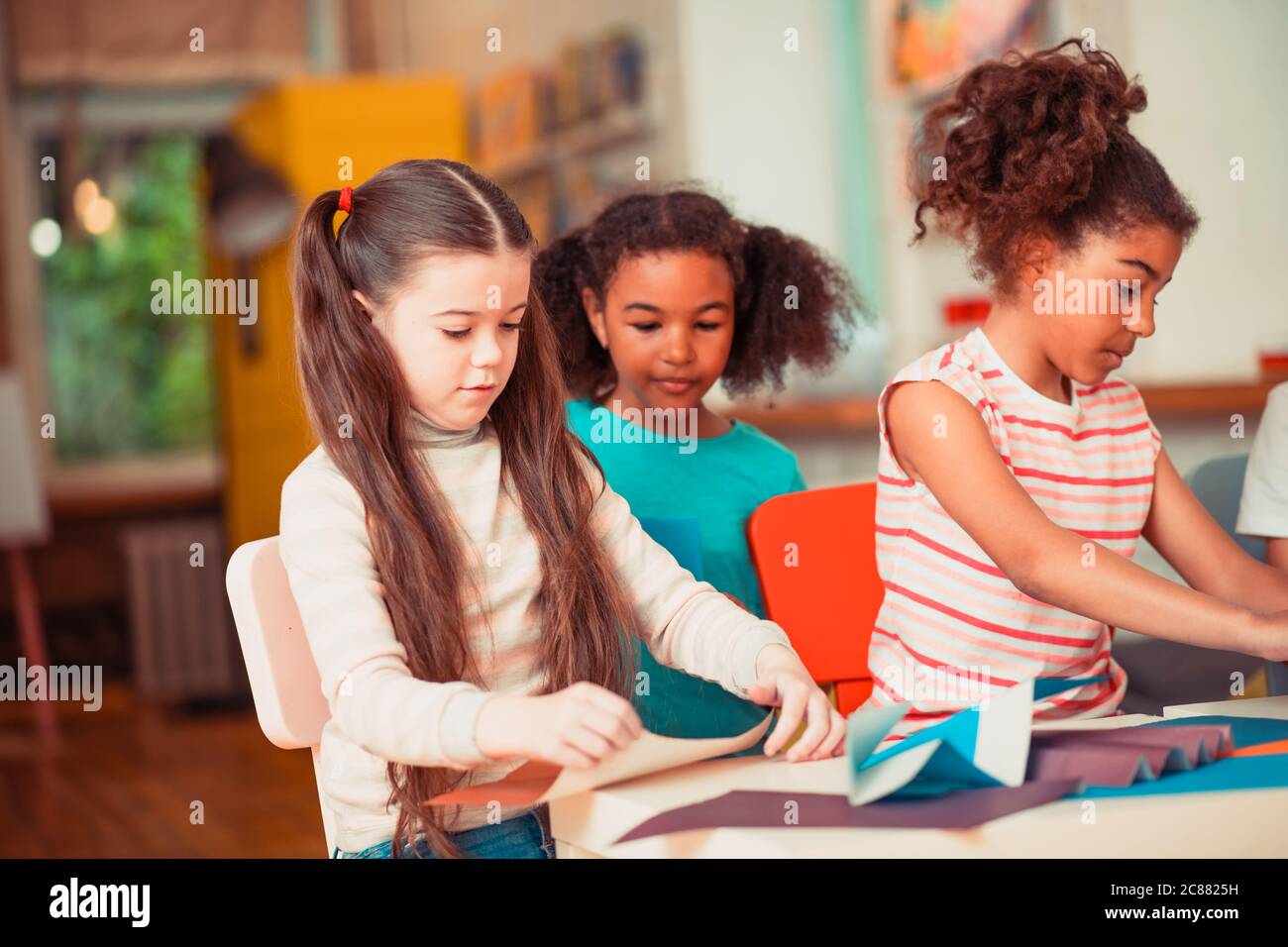 Kids learning to make paper figures at school Stock Photo - Alamy