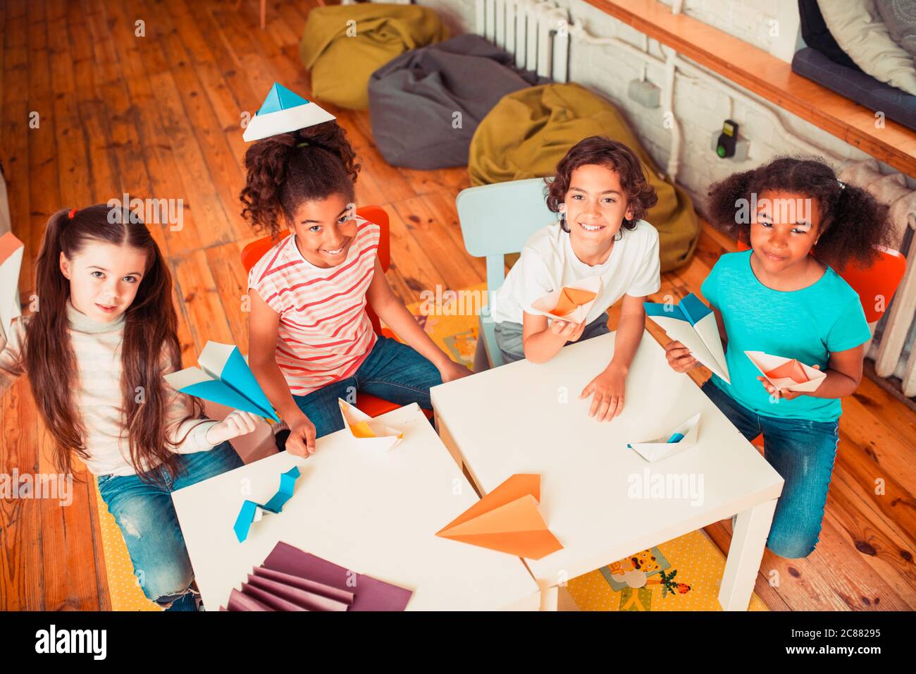 Joyful children making paper crafts at school Stock Photo - Alamy