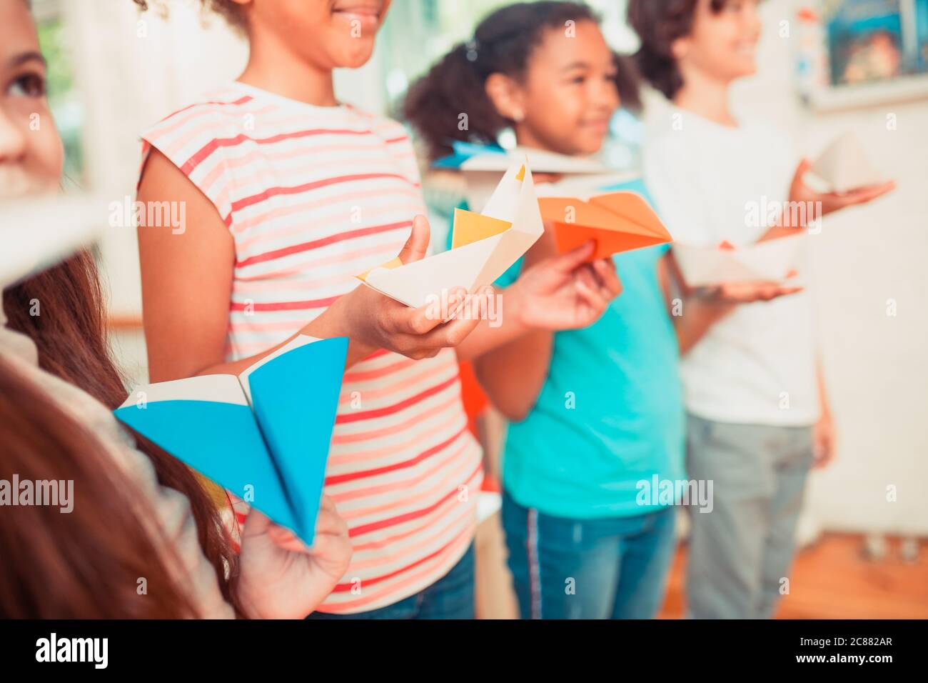 Group of schoolchildren holding their colorful paper crafts Stock Photo ...