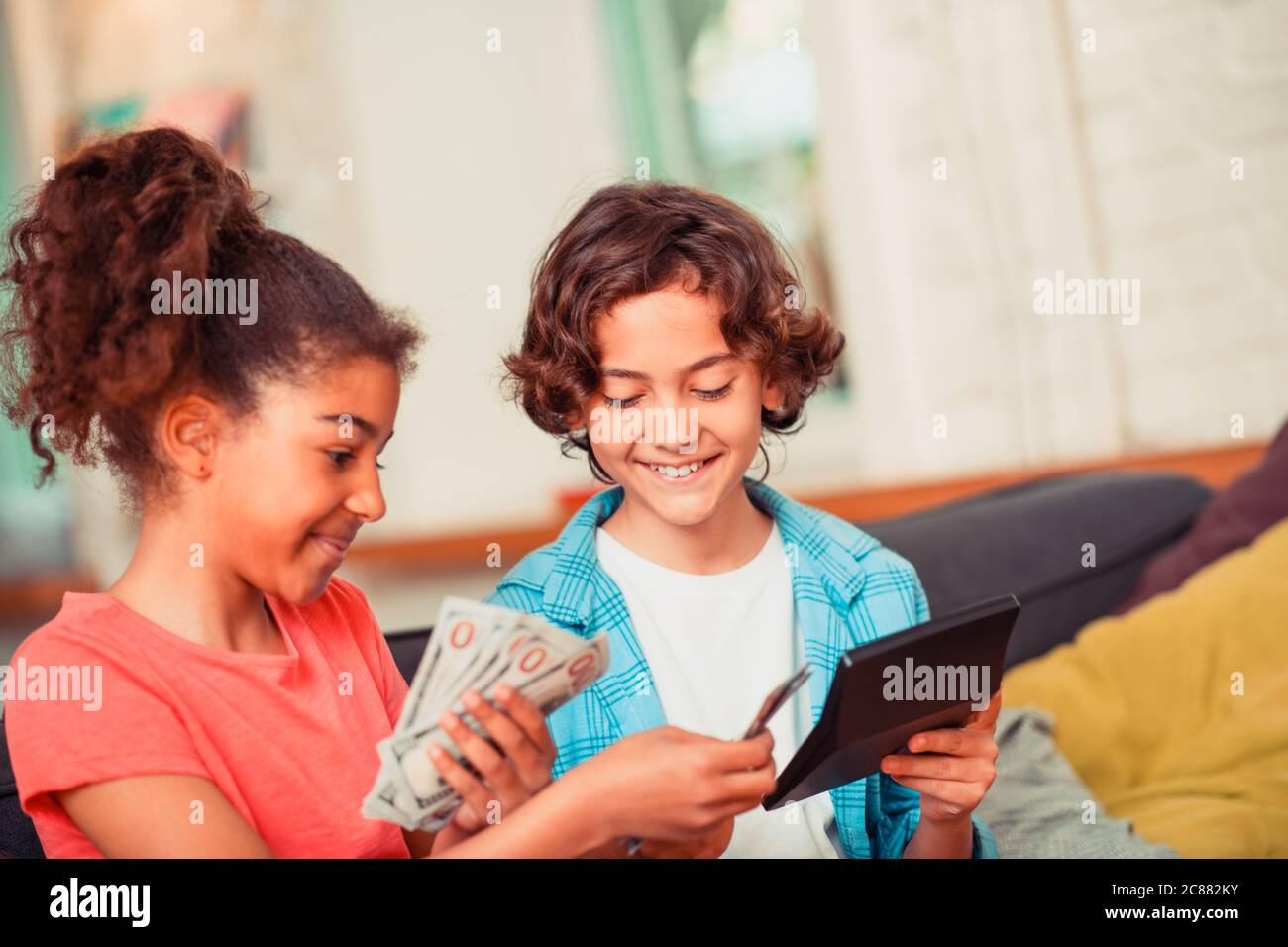 Boy and a girl learning to plan a budget Stock Photo - Alamy