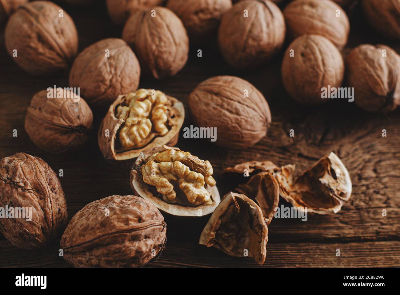 Walnut kernels in a shell on rustic wooden table. Healthy eating Stock ...