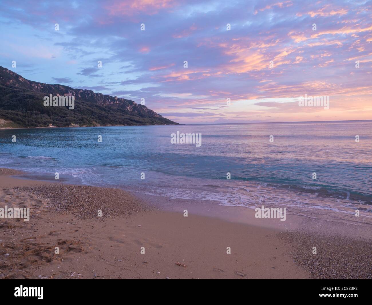 beautiful pastel pink orange and golden sunset clouds and waves at sea ...