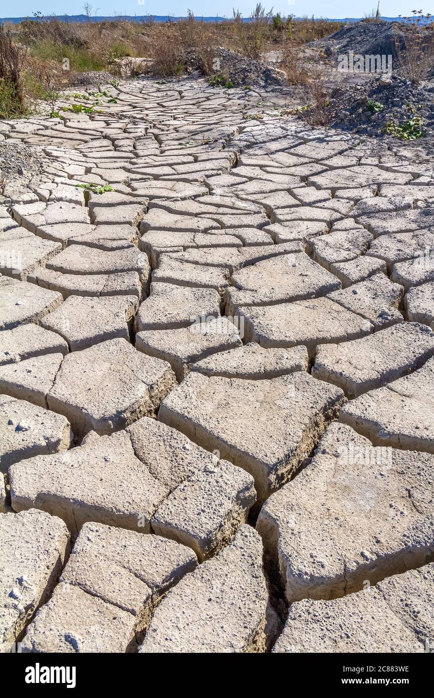 sunny arid scenery including lots of fissured dry ground Stock Photo ...