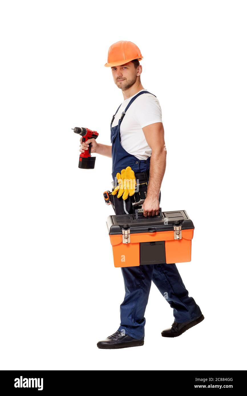 caucasian repairman worker in uniform and helmet holding cordless ...