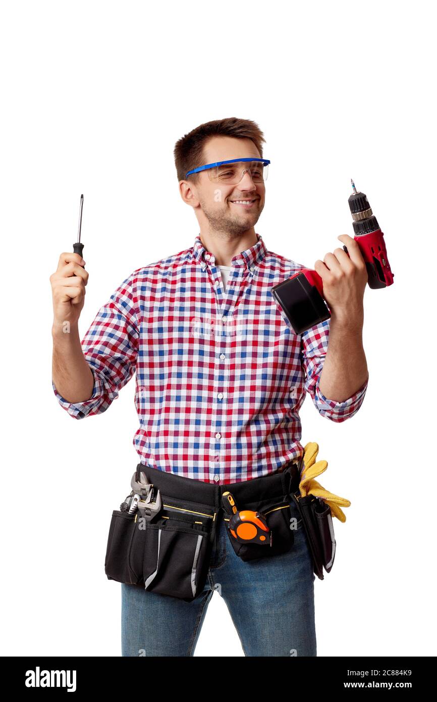 repairman worker chooses between cordless screwdriver and screwdriver ...