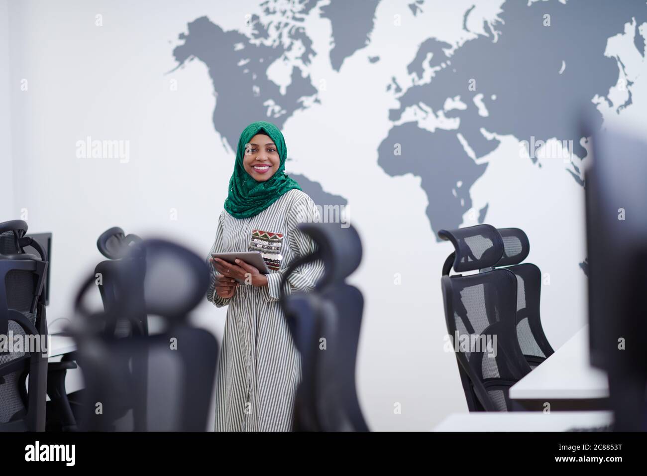 Portrait of muslim african female software developer with green hijab ...