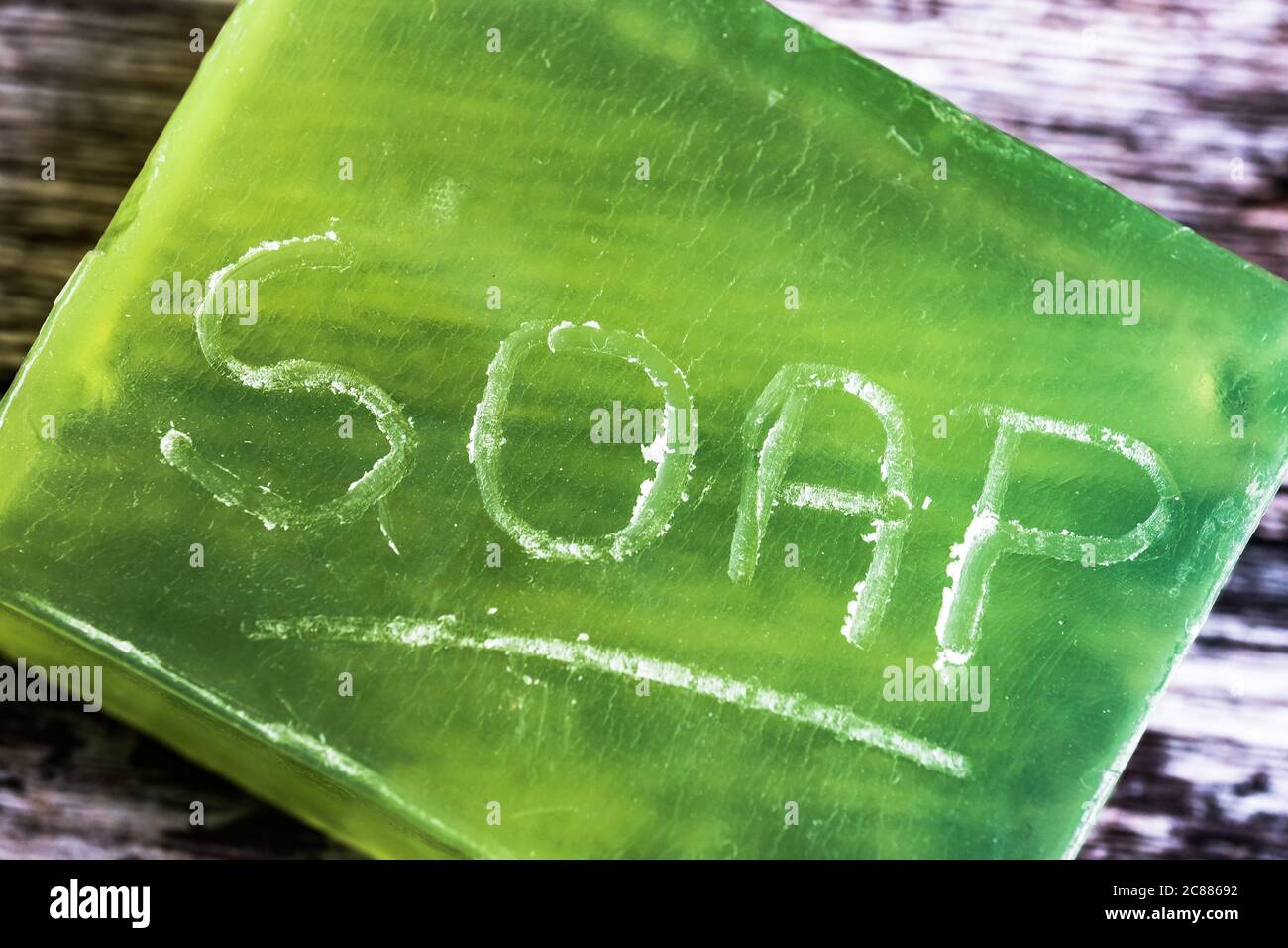 Close-up, shallow focus of a bar of natural soap with engraved letters ...