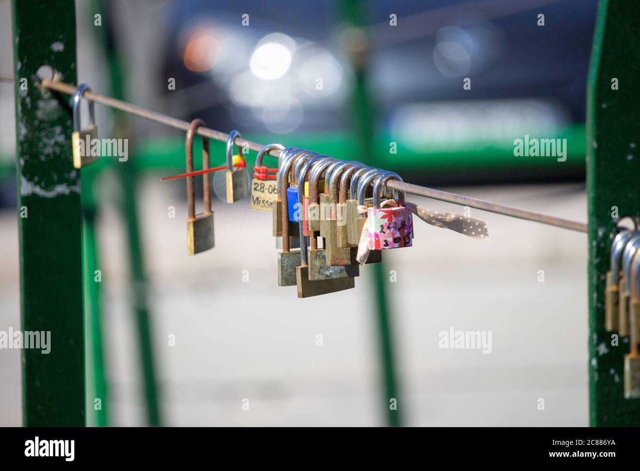 Closeup hot of hanging metal locks on a metal railing Stock Photo - Alamy