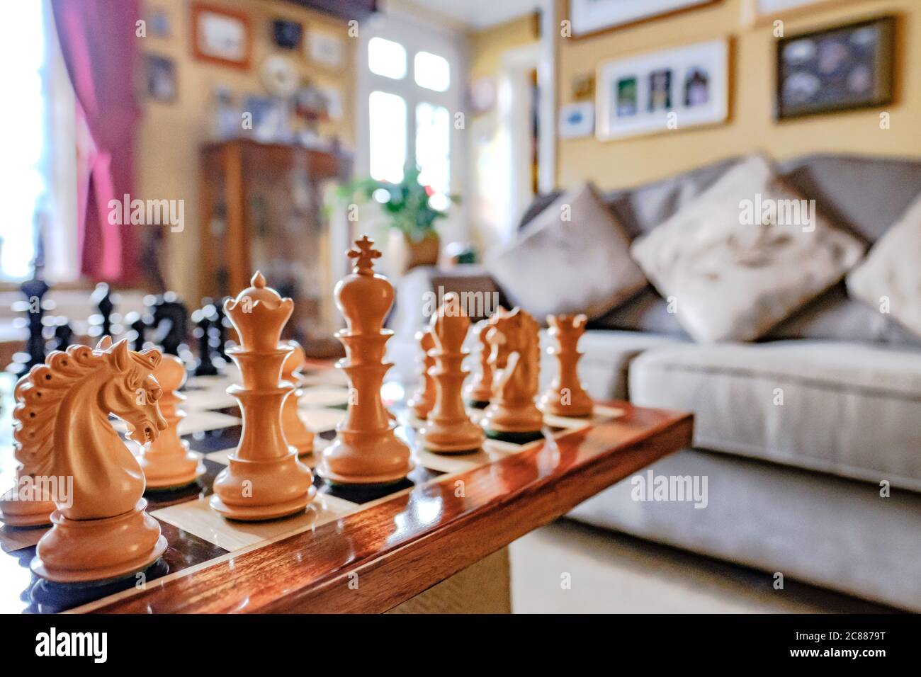Close-up, shallow focus view of a wooden, carved chess set seen within ...