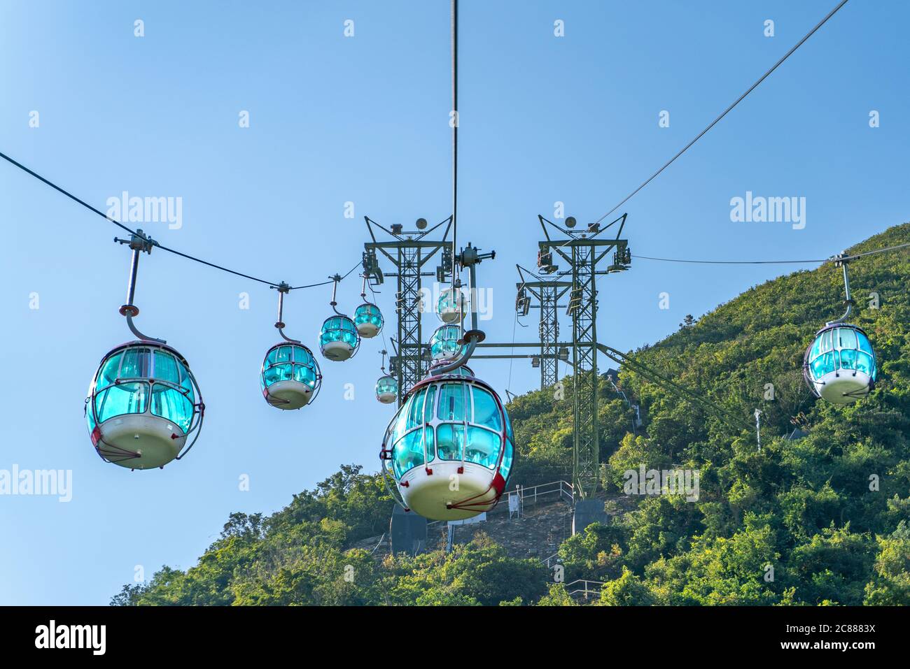 The sunny view of cable car and theme park near to ocean Stock Photo ...