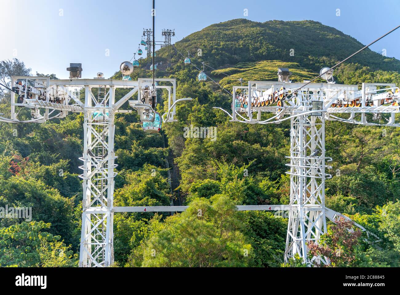 The sunny view of cable car and theme park near to ocean Stock Photo ...