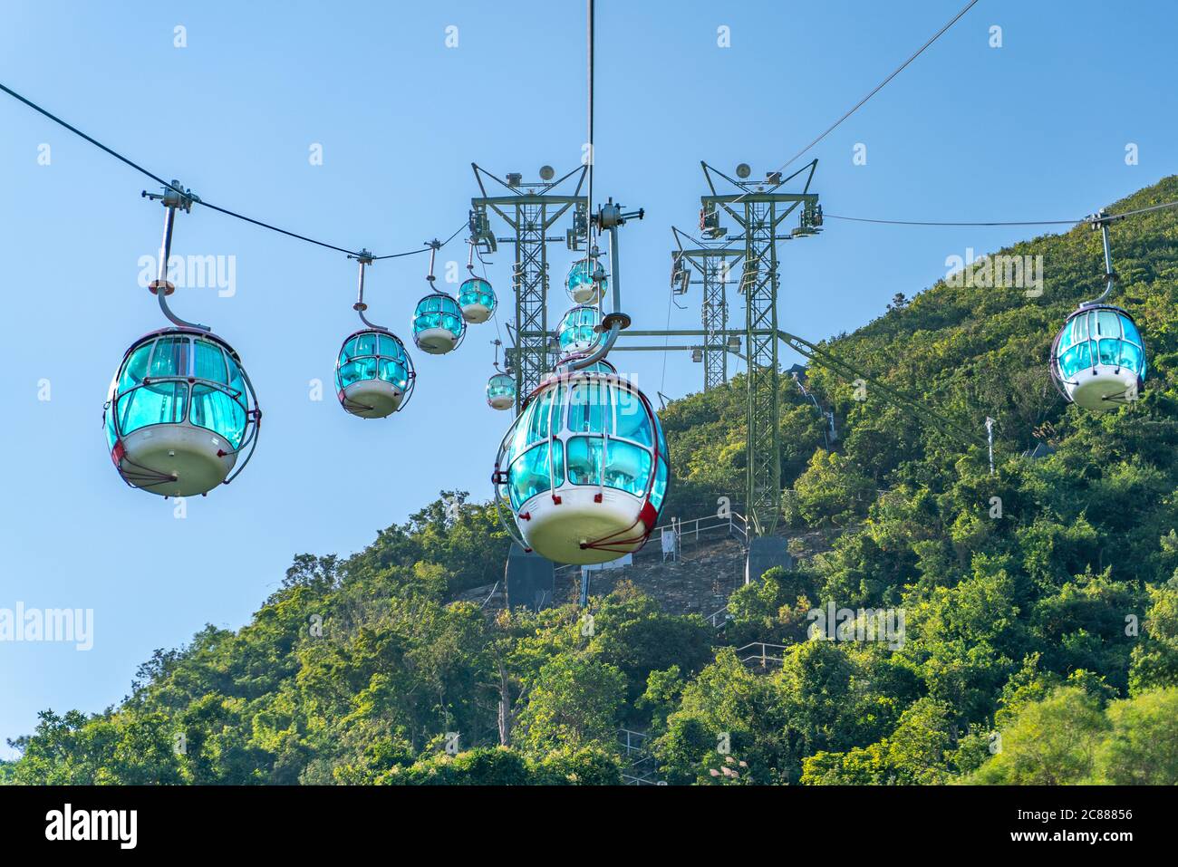 The sunny view of cable car and theme park near to ocean Stock Photo ...