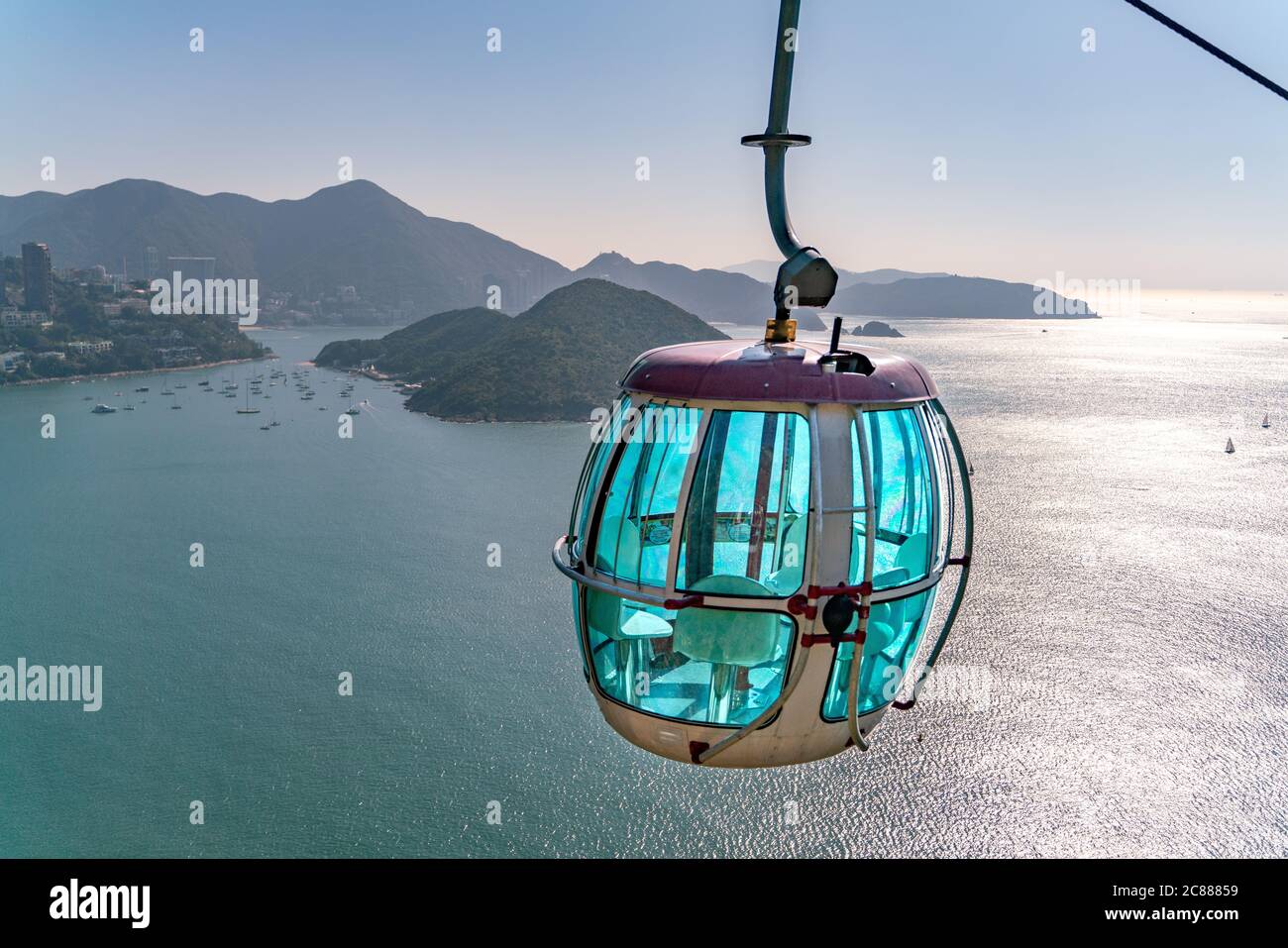 The sunny view of cable car and theme park near to ocean Stock Photo ...