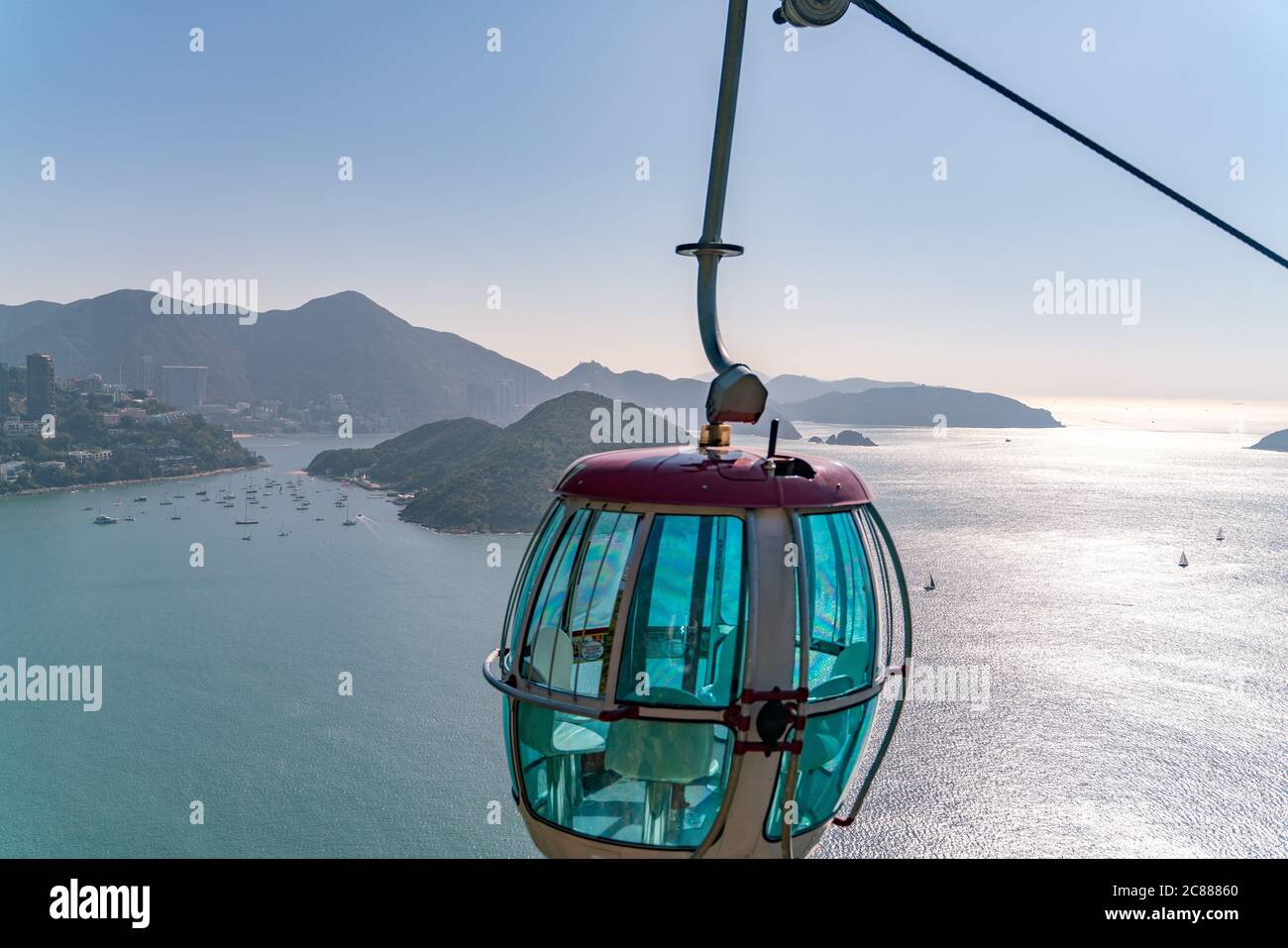 The sunny view of cable car and theme park near to ocean Stock Photo ...