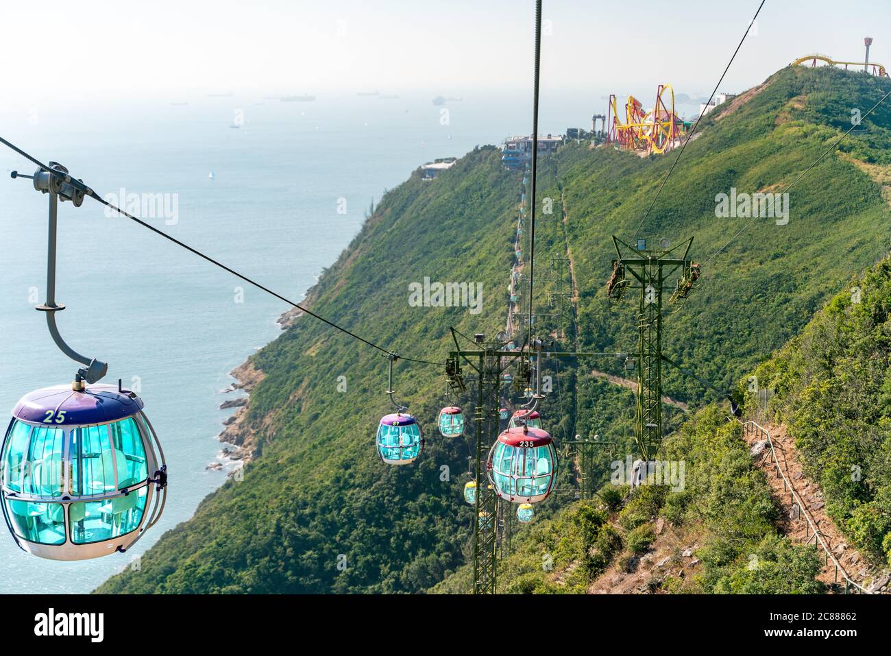 The sunny view of cable car and theme park near to ocean Stock Photo ...