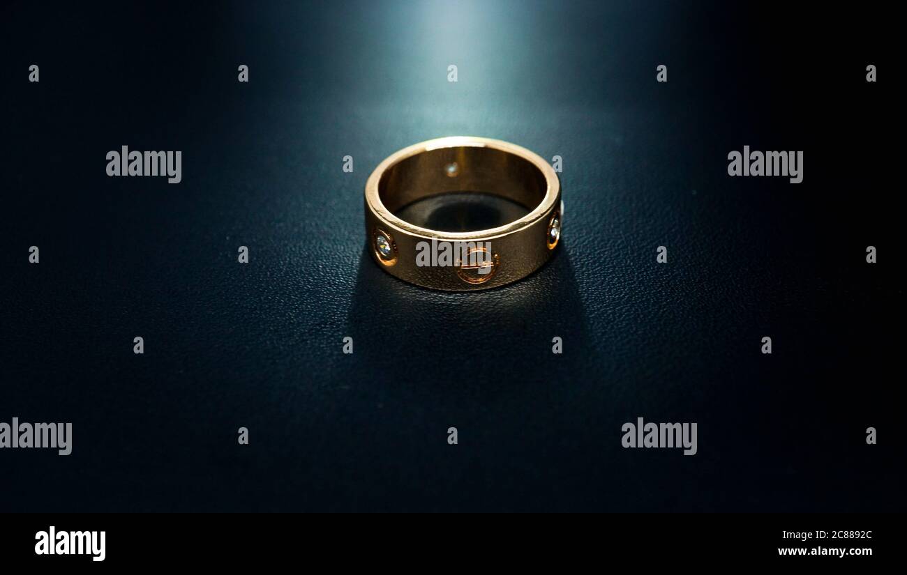 wedding rings on black background Stock Photo - Alamy