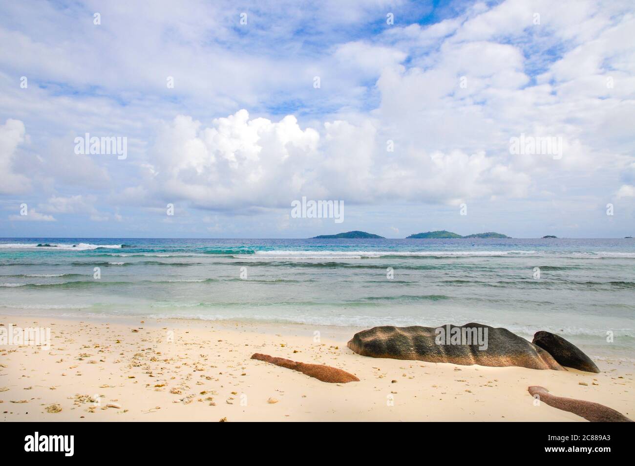 Idyllic tropical remote beach with granitie rock and blue sky in Anse ...