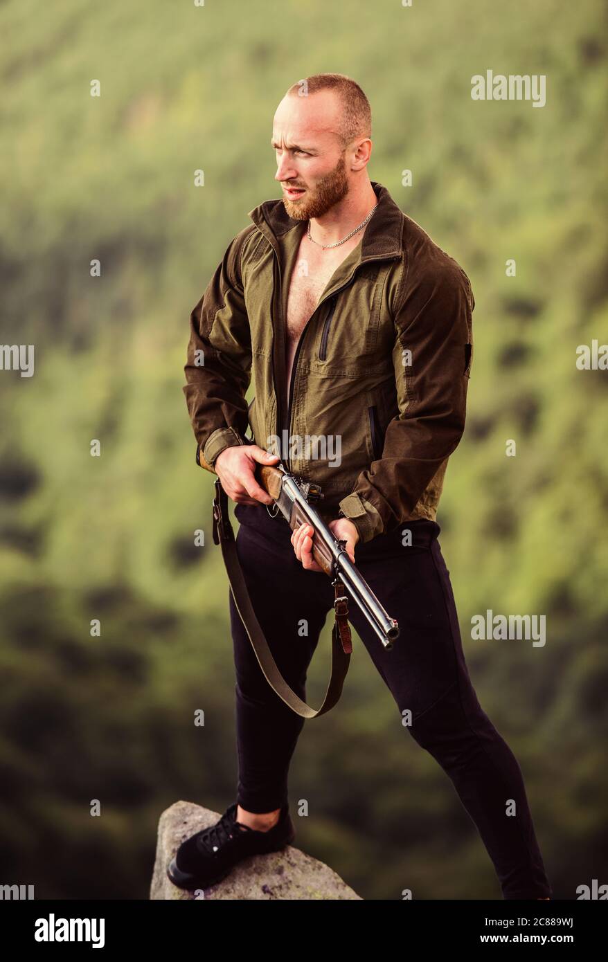 Man brutal poacher with weapon natural landscape background. Hunter ...